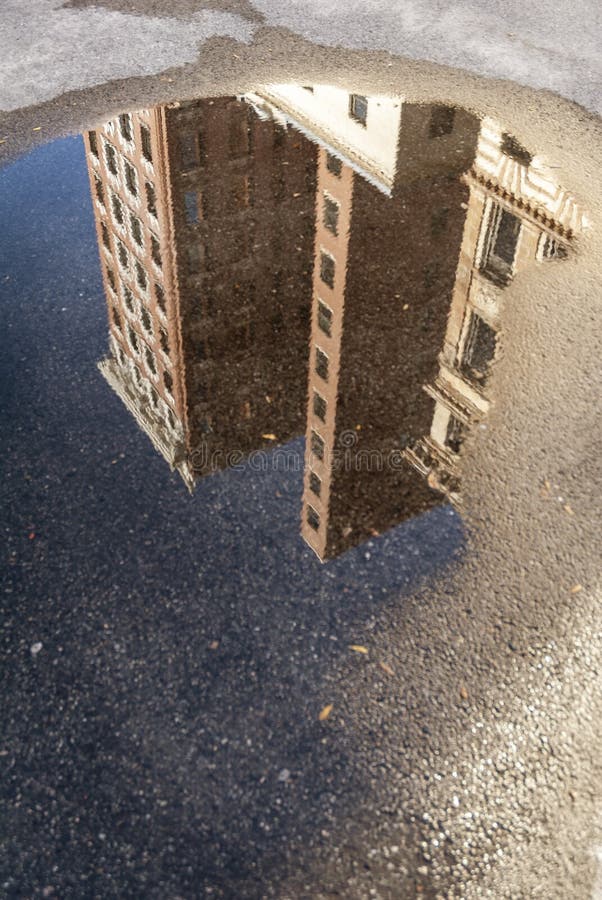 Tall Buildings Reflected in Drying Puddle Stock Image - Image of puddle ...