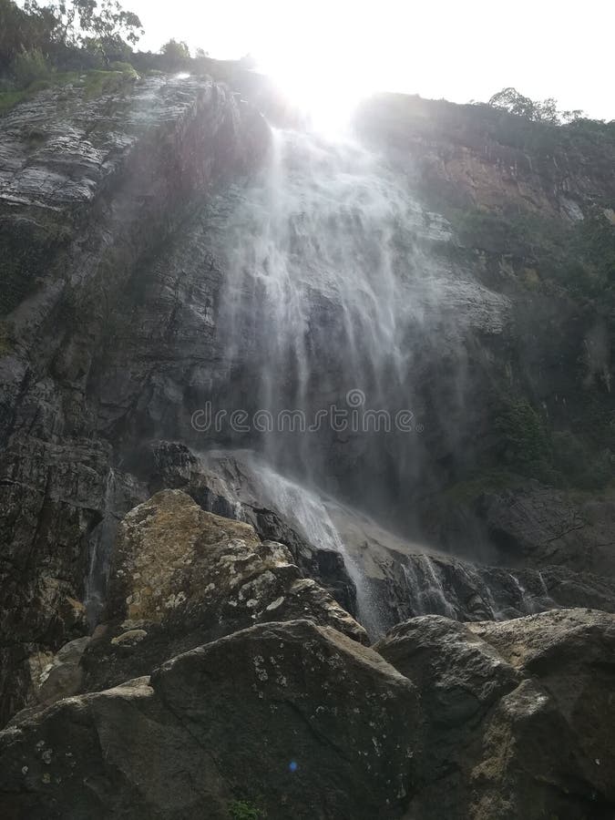 A tall cascading waterfall stock image. Image of falling - 264396473