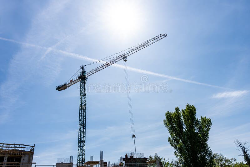 Tall Construction Crane Operating Above Partially Built Structures ...