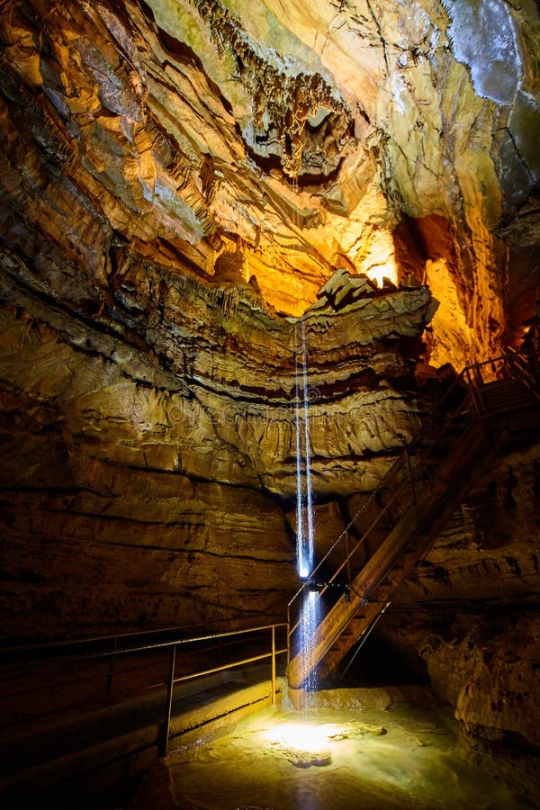 Tall Dripping Water into Large Underground Cave by Path and Staircase ...