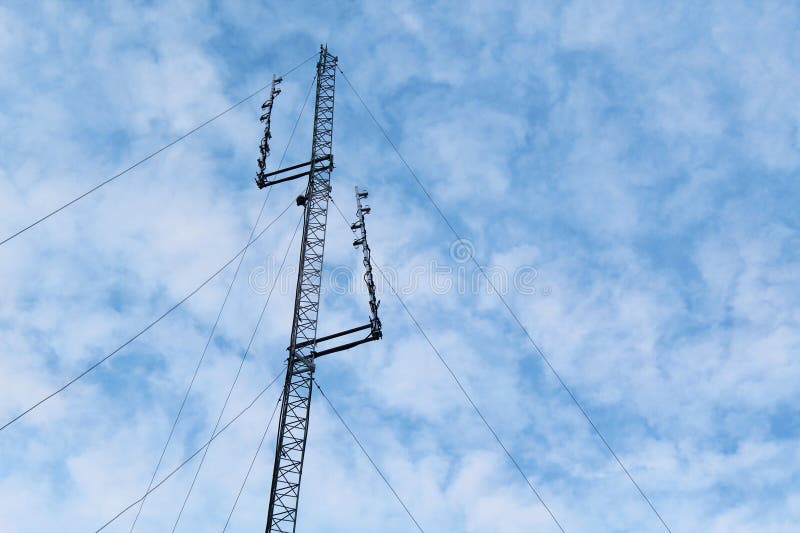 Tall Electricity and Network Pole with Its Cables Against Bright Cloudy ...