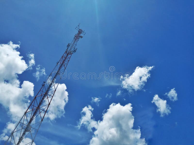 Tall Electricity and Network Pole with Its Cables Against Bright Cloudy ...