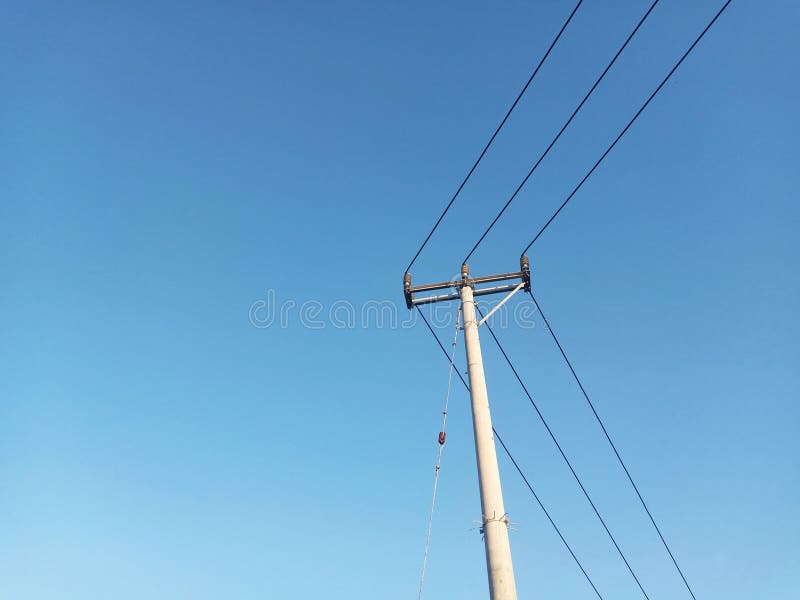 Tall Electricity Pole with Its Wires or Cables Against Clear Blue Sky ...