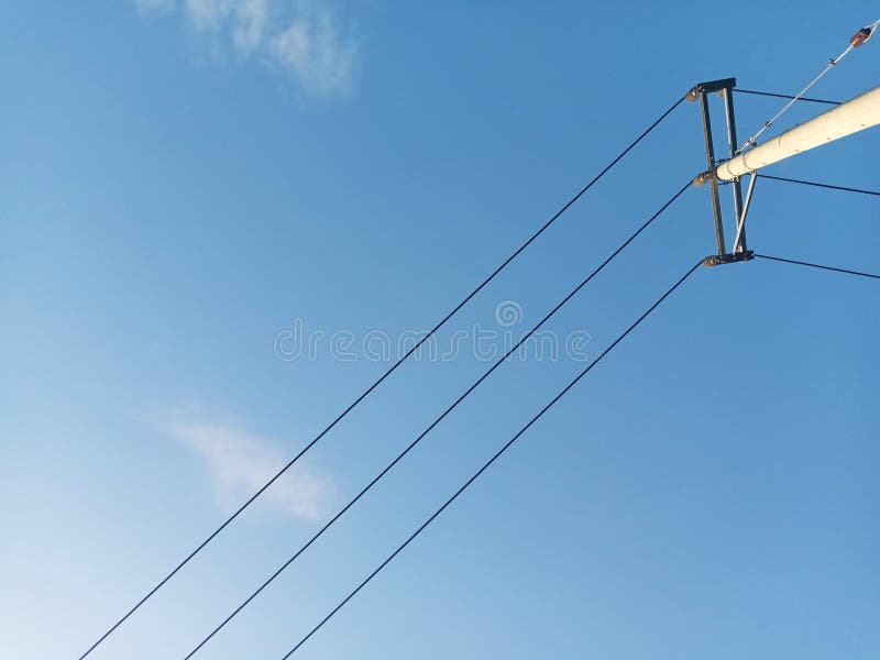 Tall Electricity Pole with Its Wires or Cables Against Clear Blue Sky ...
