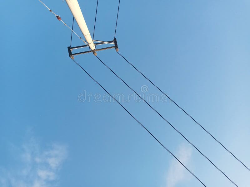 Tall Electricity Pole with Its Wires or Cables Against Clear Blue Sky ...