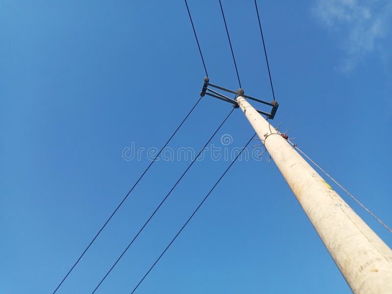 Tall Electricity Pole with Its Wires or Cables Against Clear Blue Sky ...