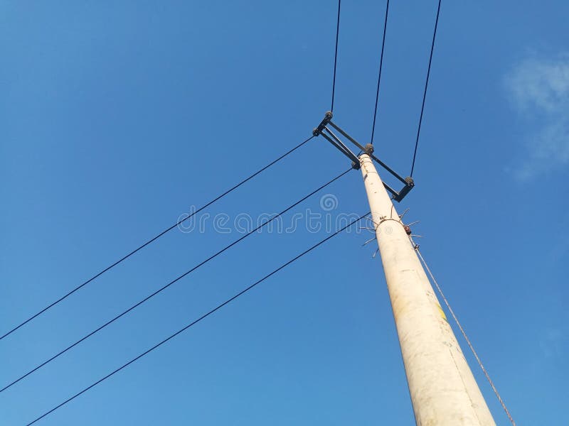 Tall Electricity Pole with Its Wires or Cables Against Clear Blue Sky ...