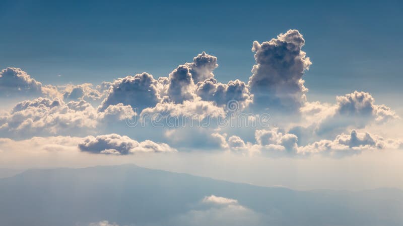 Tall Fluffy Clouds at Eye Level and the Hint of Mountain Range Below ...