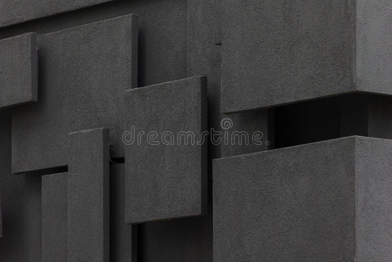 A Tall Gray Building with Square Openings at the Top and One Window ...