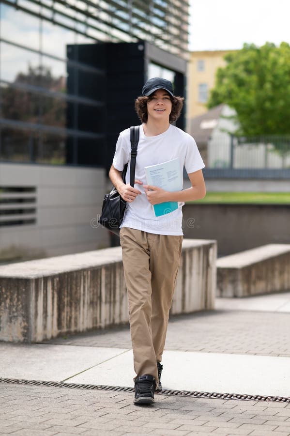 Tall Guy in White Tshirt and Beige Pants Walking Near the Building ...