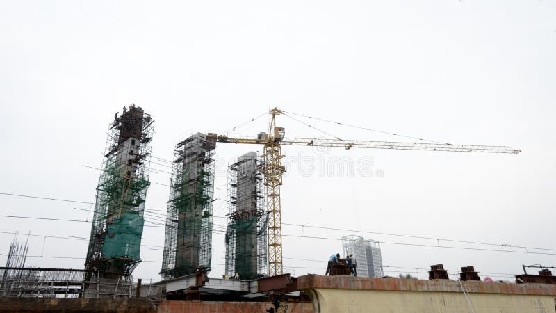 A Tall High Crane Equipment Work in Progress in a Construction Site of ...