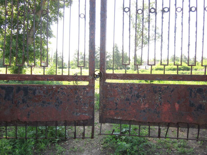 Tall Iron and Rusty Gate Shutters Stock Image - Image of high, obstacle ...