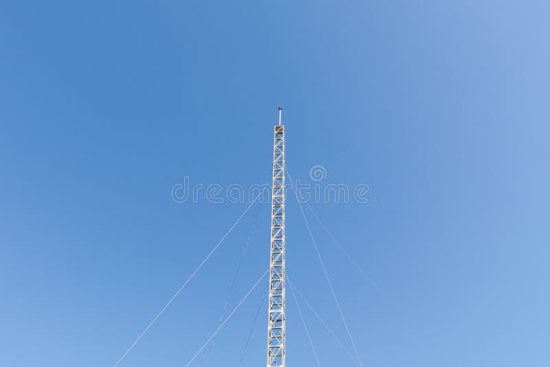 A Tall Iron Tower Against a Blue Sky. a Tower with a Beacon at the End ...