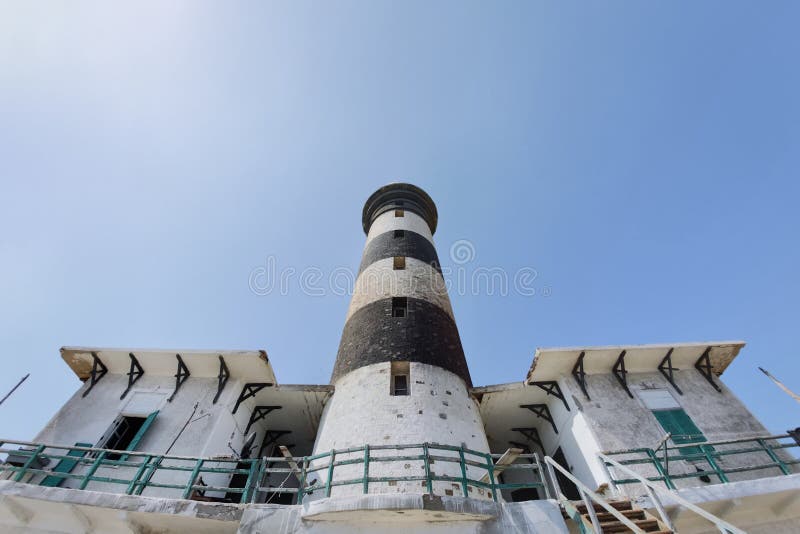 Tall lighthouse on the sea stock image. Image of travel - 145474793