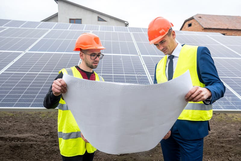 Tall Men in Work Clothes are Considering Whether To Install Solar ...
