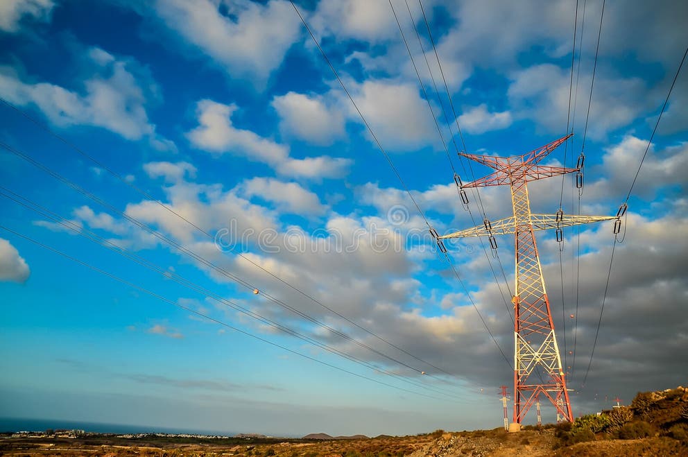 A Tall Power Line Tower is in the Middle of a Field Stock Photo - Image ...