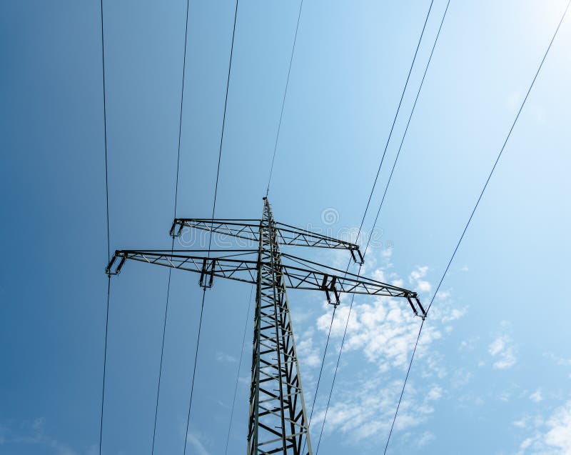 A Tall Power Line Tower is Seen Against a Blue Sky Stock Photo - Image ...