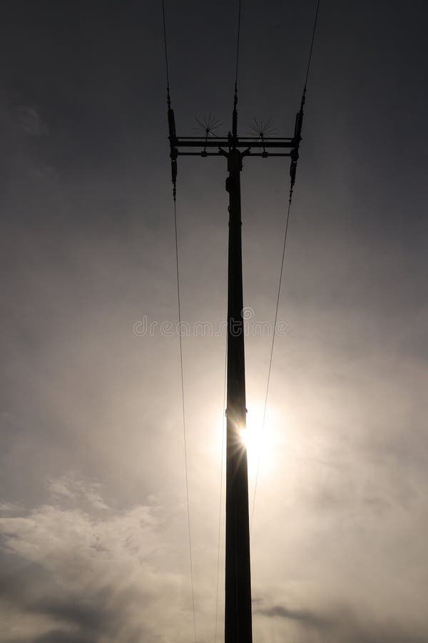 A Tall Power Pole with a Sun Shining on it Stock Photo - Image of pole ...