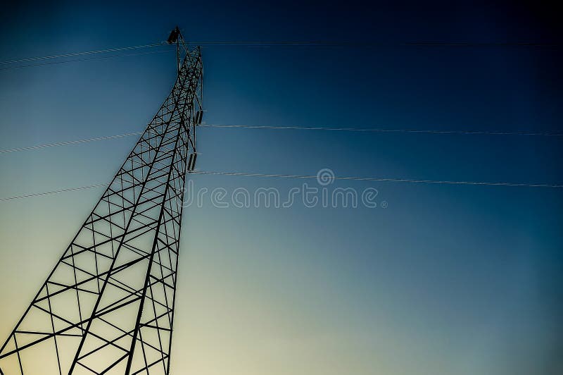A Tall Power Tower is Lit Up at Night Stock Photo - Image of network ...