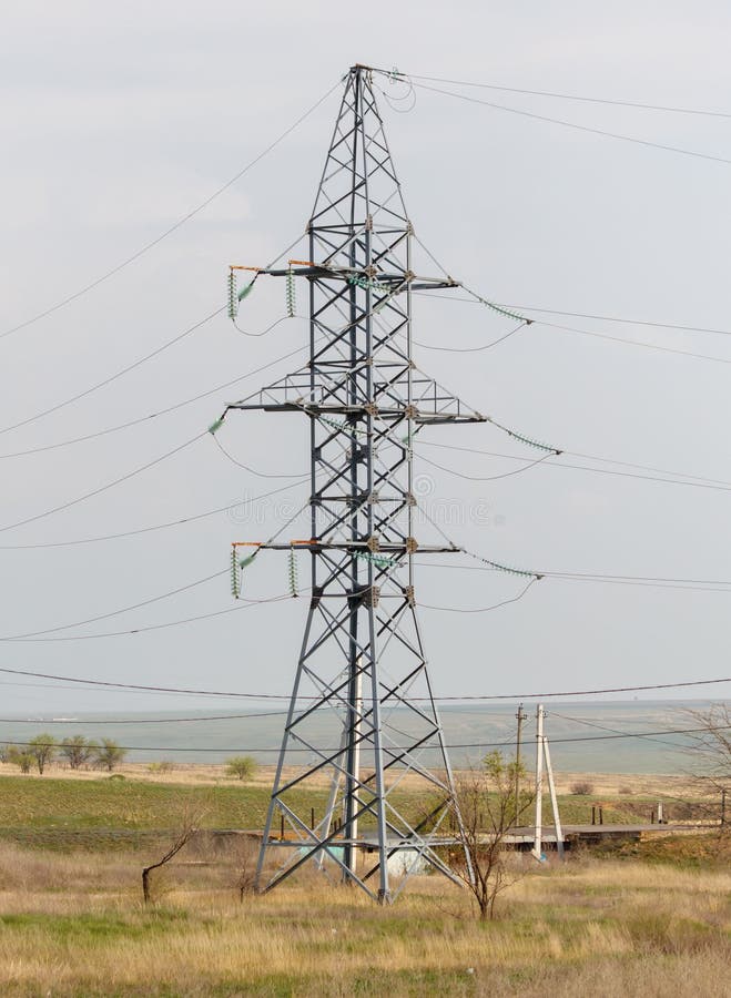 A Tall Power Tower is Standing in a Field Stock Photo - Image of wire ...
