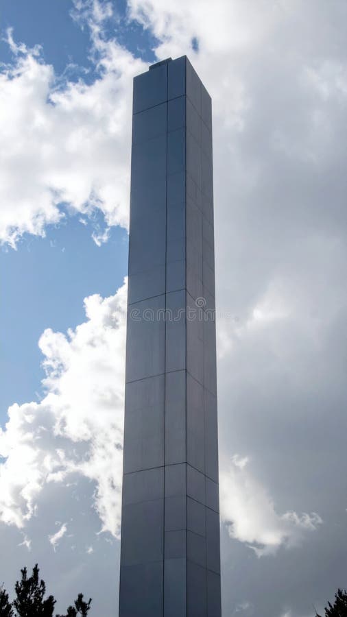Tall Rectangular Mirrored Skyscraper Reflecting Sky and Clouds in Sunny ...