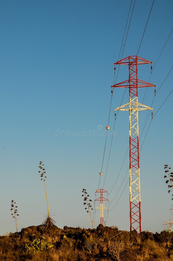 A Tall Red and White Power Pole Stands in a Field Stock Image - Image ...