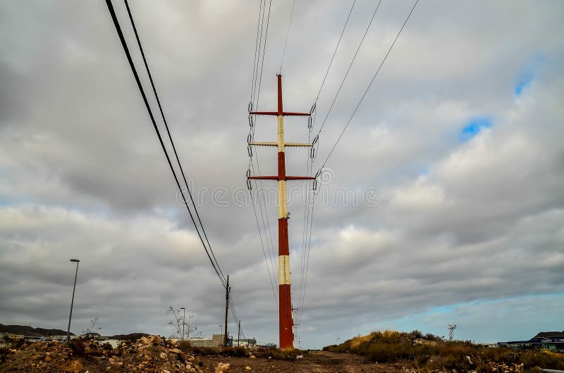A Tall Red and White Power Pole Stands in a Field Stock Photo - Image ...