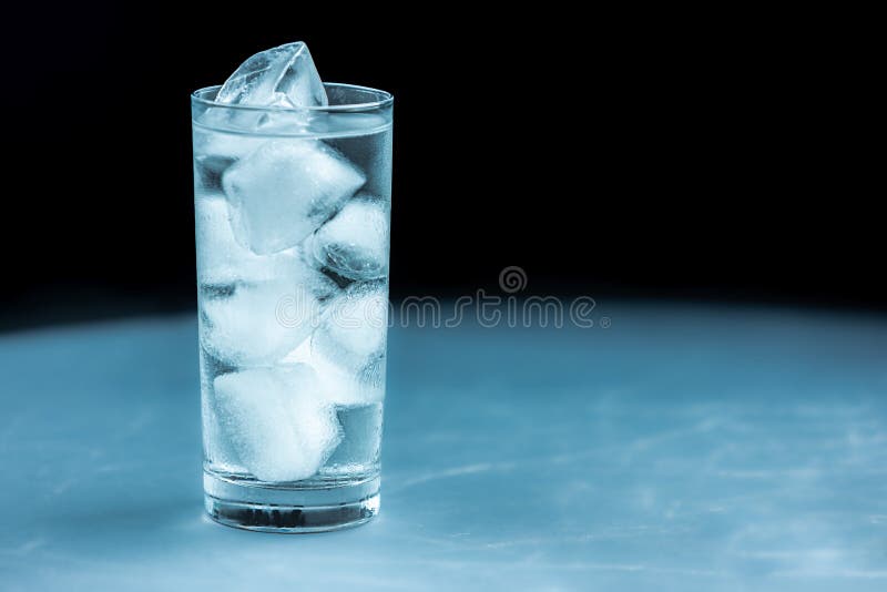 Tall, Refreshing Glass Full of Water and Ice Cubes Above a Planet Stock ...