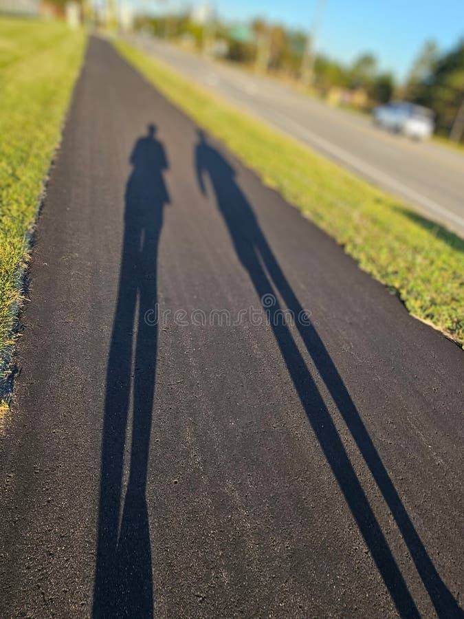 Tall Shadows Two People Paved Walking Trail Next Street Stock Photos ...