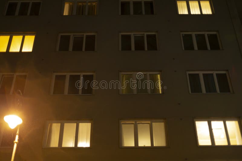 A Tall, Spacious Building with Large Windows is Lit Up at Night Stock ...
