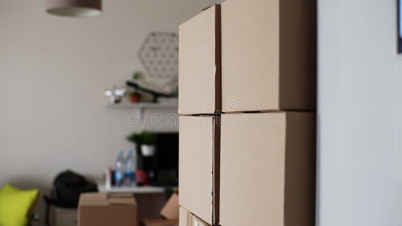 Tall Stack of Cardboard Boxes Collapsing in Living Room with Modern ...