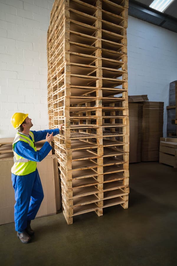 Tall Stack of Wooden Pallets Standing Under Skylights in Warehouse Area ...