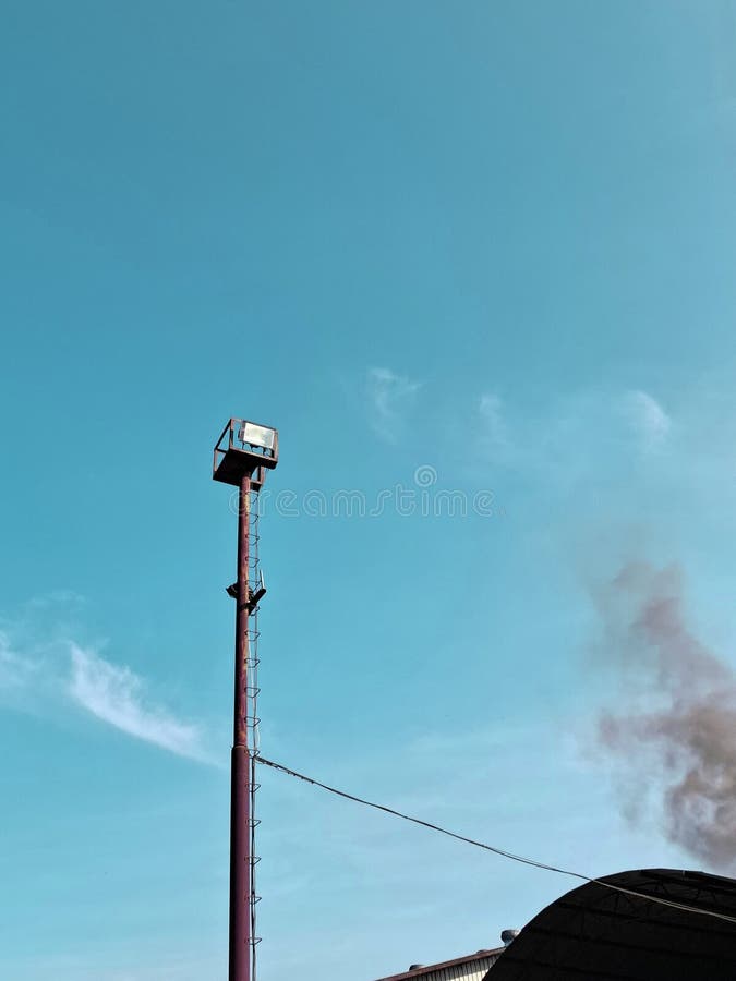 A Tall Tower with Lights on Top with Beautiful Blue Sky Stock Photo ...