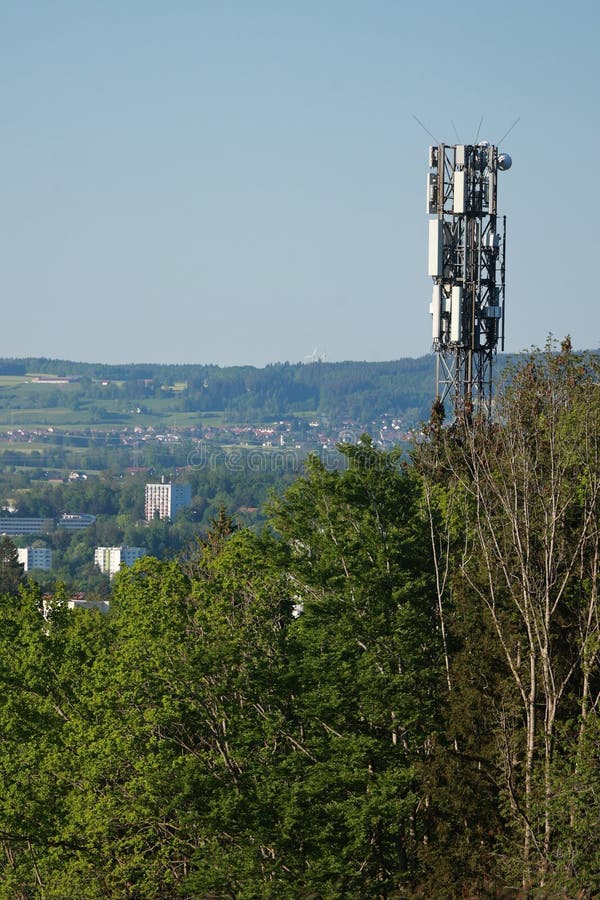 A Tall Tower Sits Above the Water and Many Buildings in it Stock Image ...