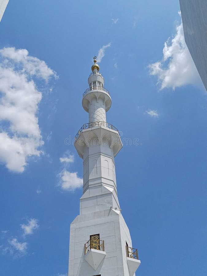 The Tall Tower of Mosque Against Blue Sky and Cloud Stock Photo - Image ...