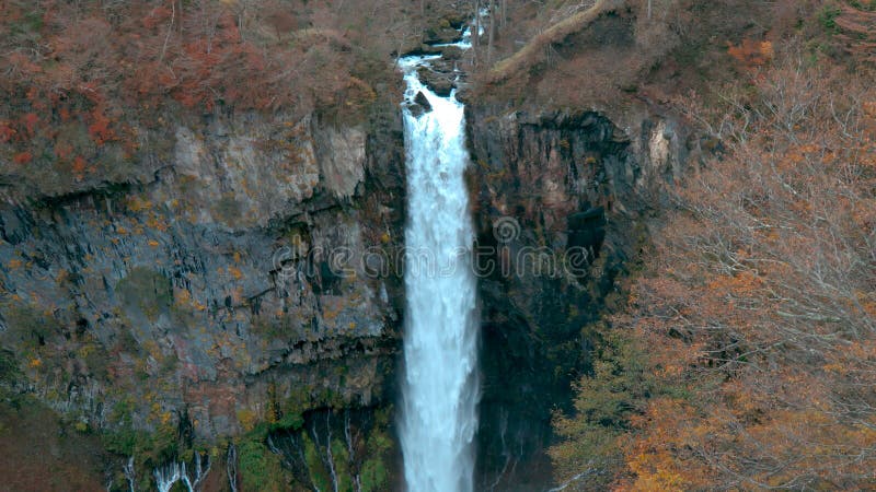 Tall Waterfall Cascading Down Rugged Cliff Face, Surrounded by Bare ...