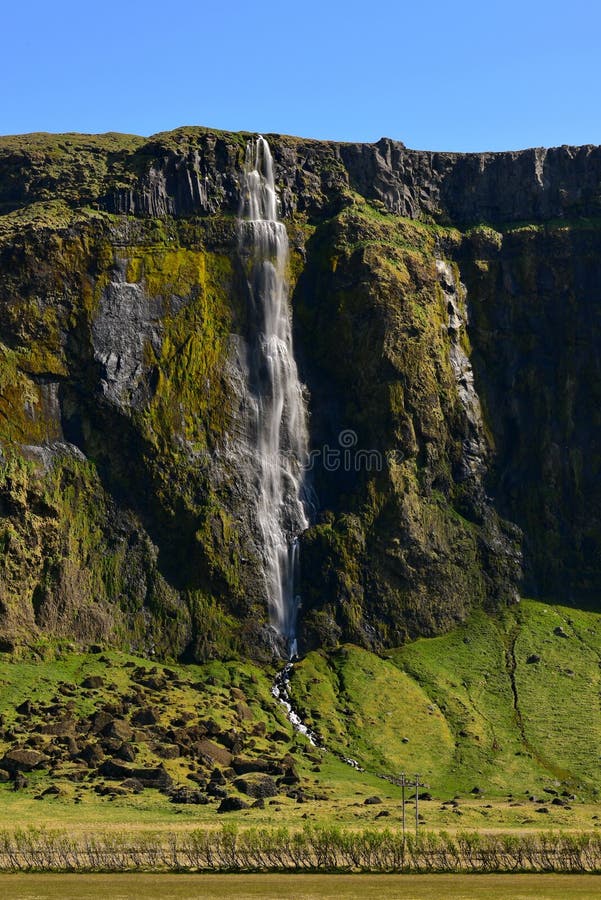 Tall waterfall in Iceland stock image. Image of rock - 73858279