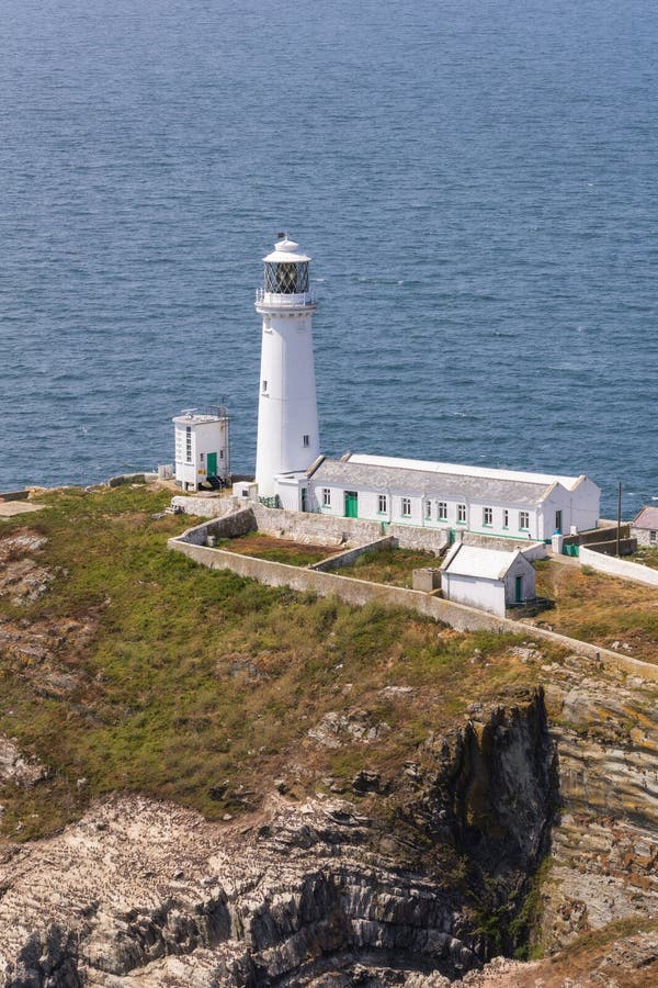 Tall White Stone Lighthouse at the Edge of the Cliffs on a Rugged ...
