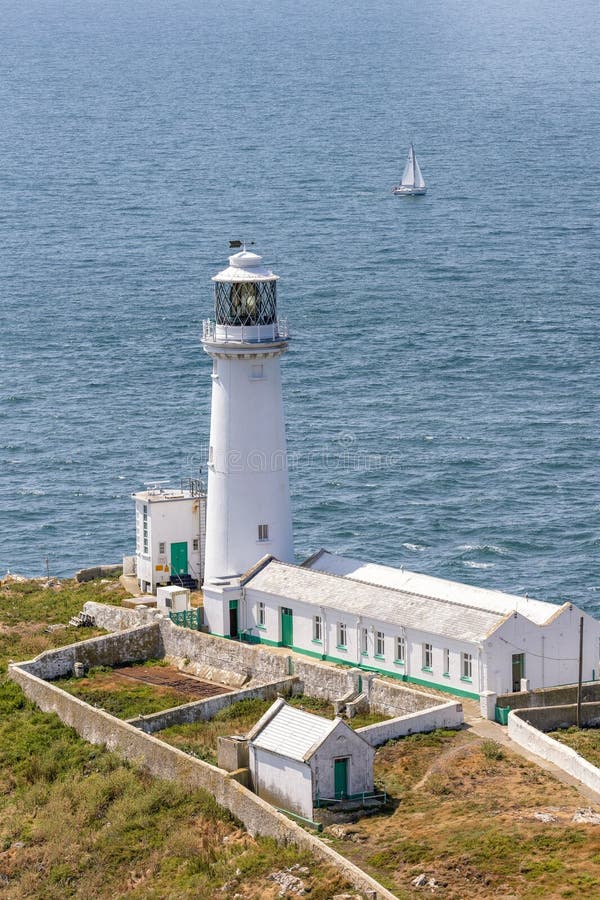 Tall White Stone Lighthouse at the Edge of the Cliffs on a Rugged ...