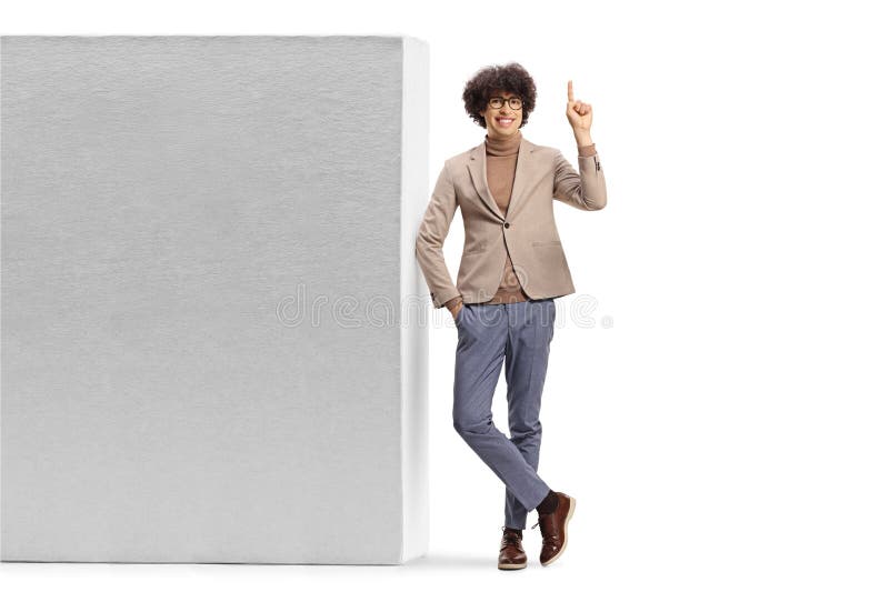 Tall Young Man Leaning on a Wall and Pointing Up Stock Photo - Image of ...
