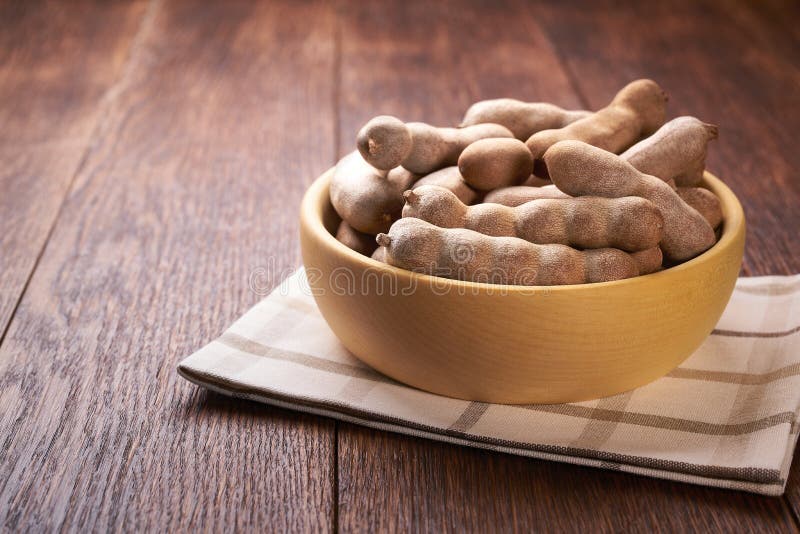 Tamarind in a Wooden Bowl on a Wooden Table Stock Image - Image of sour ...
