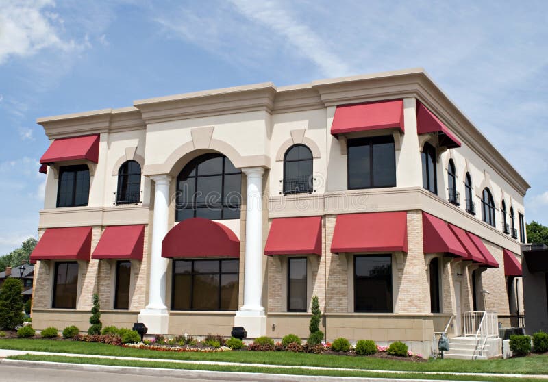 Tan Building with Red Awnings Stock Photo - Image of headquarters ...