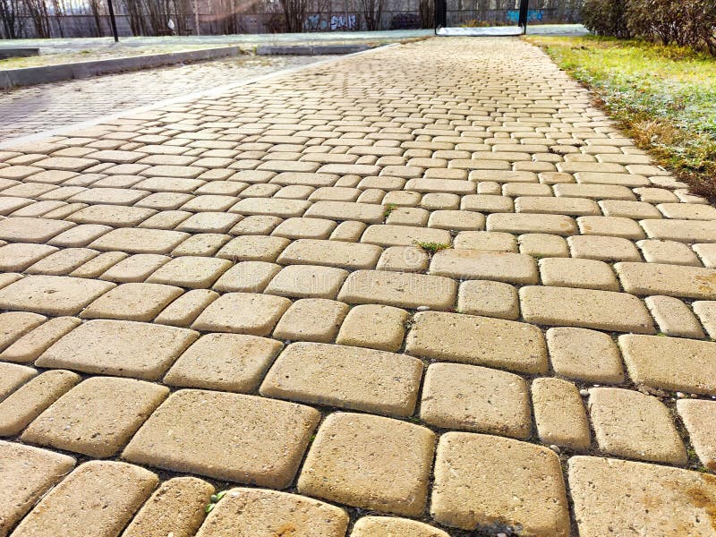 A Tan Cobblestone Pathway in a Residential Area. the Path Leads Towards ...
