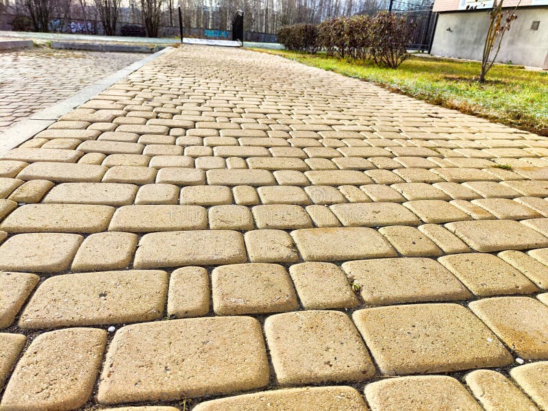 A Tan Cobblestone Pathway in a Residential Area. the Path Leads Towards ...