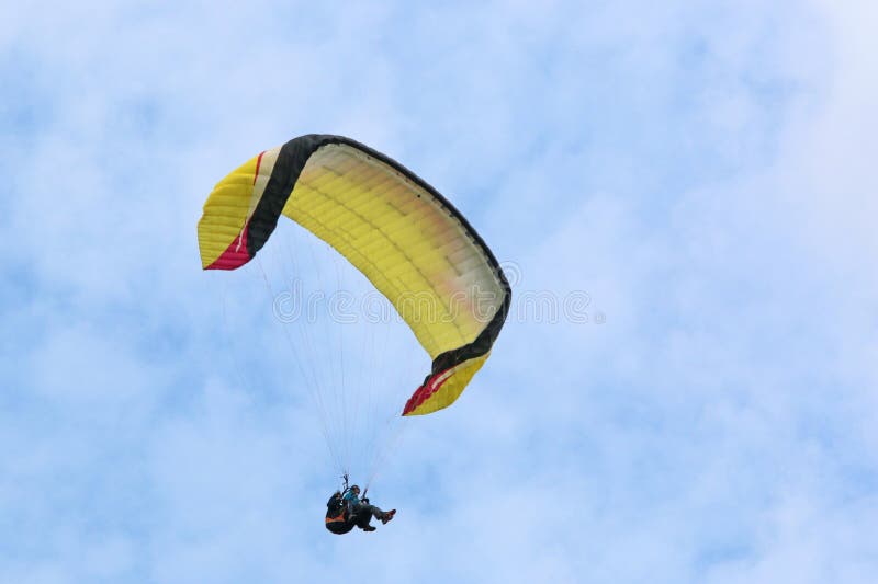 Tandem Paraglider Flying in a Blue Sky Stock Image - Image of gliding ...
