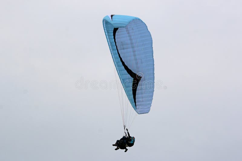 Tandem Paraglider Flying in a Cloudy Sky Stock Image - Image of ...