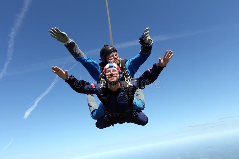 Tandem Skydiving. Two Guys are Having Fun in the Sky. Stock Image ...