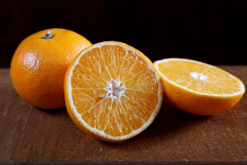 Tangerine Cut on an Old Table Stock Photo - Image of citrus, dark: 56989186