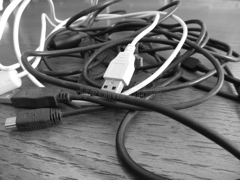Tangle of Dusty Computer Cables with Sockets on the Table . Black and ...