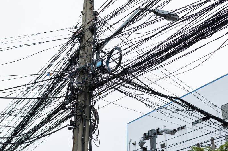 Tangle of Electrical Cables and Communication Wires on Electric Pole ...